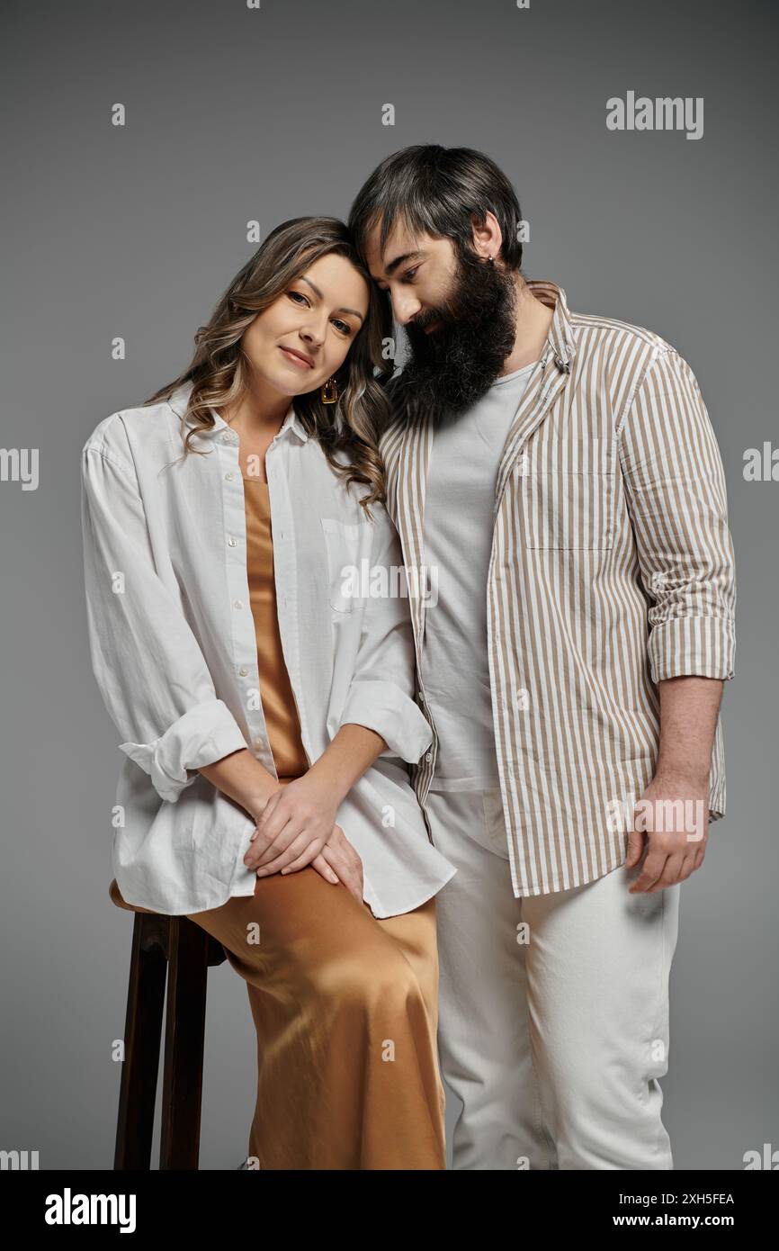 A stylish couple poses together in a studio setting Stock Photo - Alamy