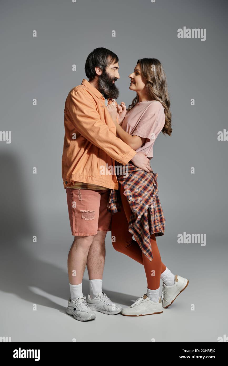 A stylish couple embraces, showcasing their affectionate connection in ...