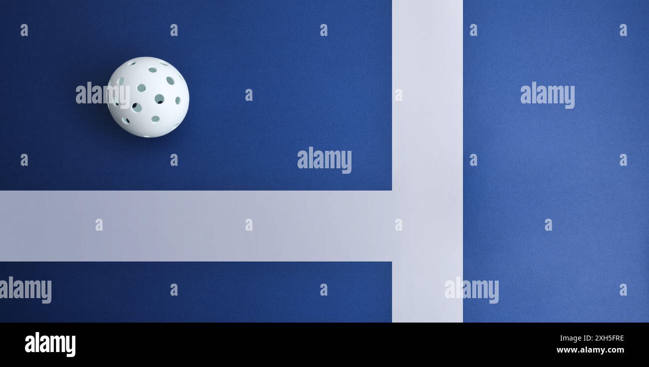 Sports background with white pickleball ball on a blue playing surface ...