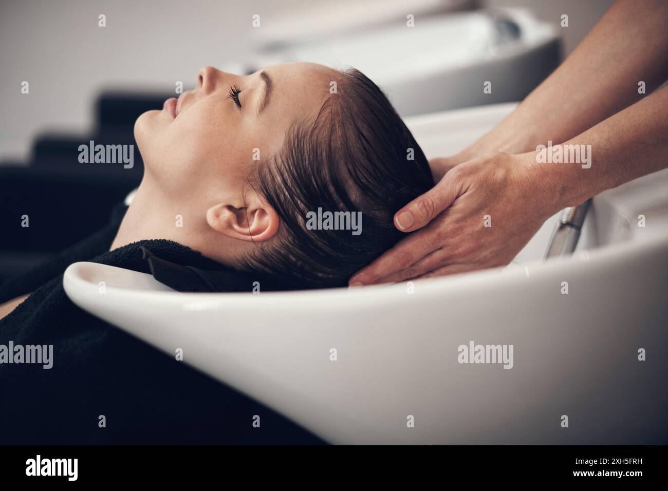 Wellness, woman or washing hair of customer in salon or basin for ...