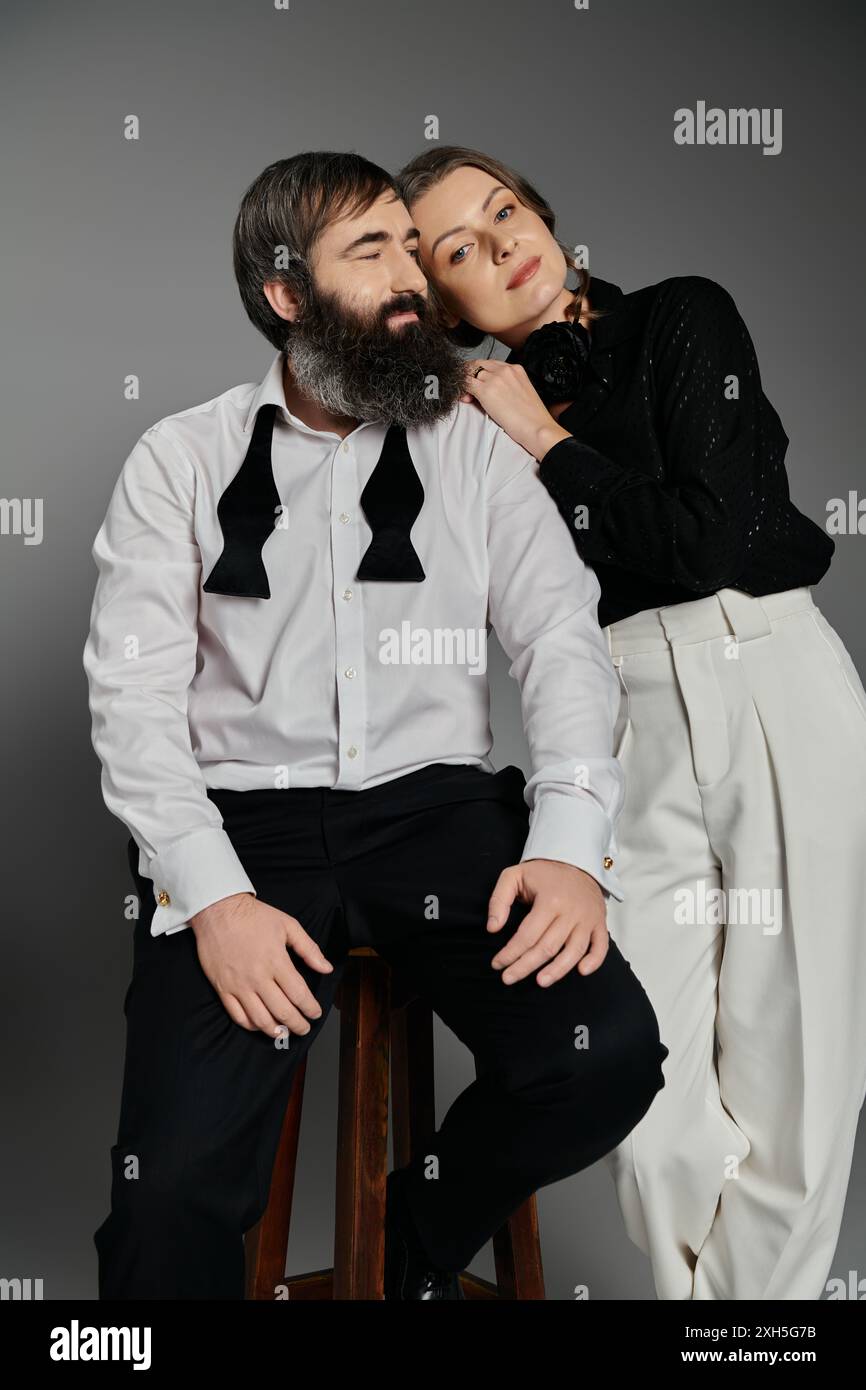 A couple dressed in formal attire poses for a portrait Stock Photo - Alamy