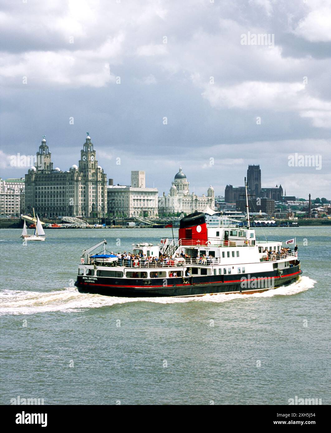 The Liverpool Ferry crossing the River Mersey with the Three Graces ...