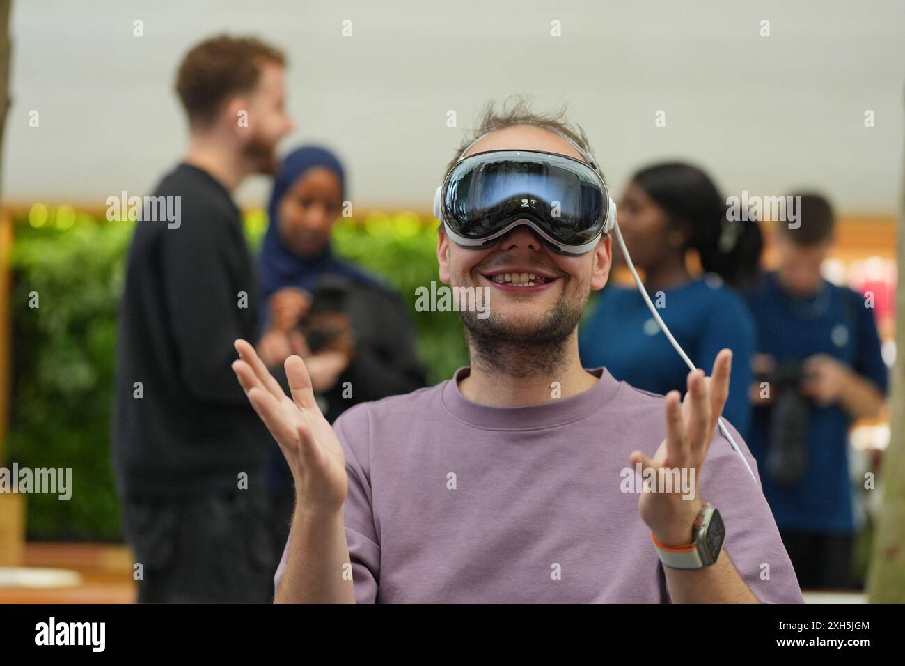 A customer tries the new Apple Vision Pro in Apple's flagship store in ...
