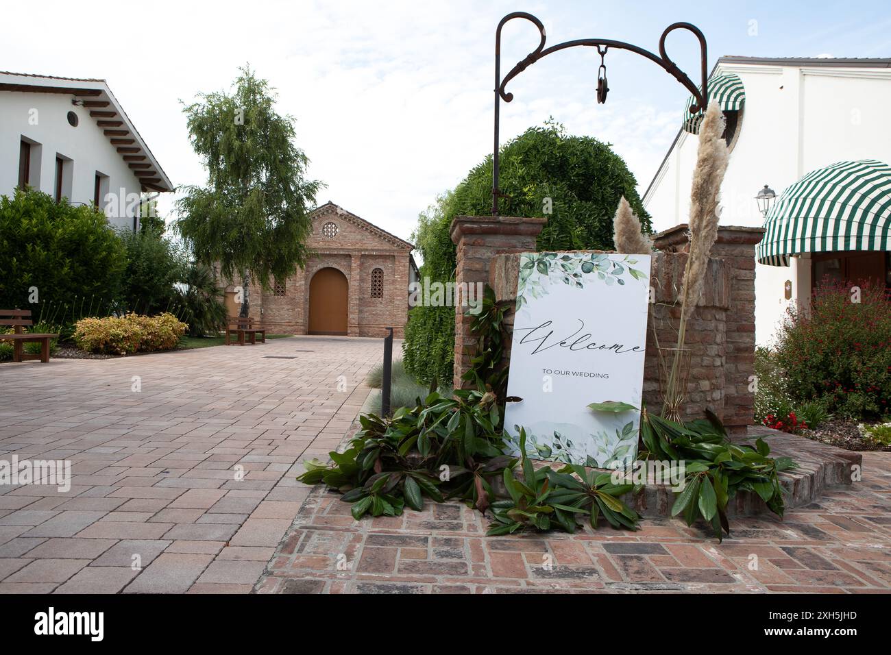Welcome sign with floral decorations is standing in the location of the ...