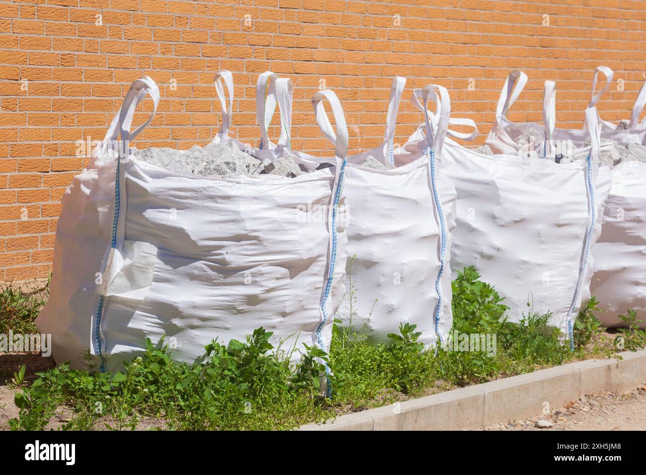 White garbage bags with building rubble and bricks, Germany Stock Photo ...