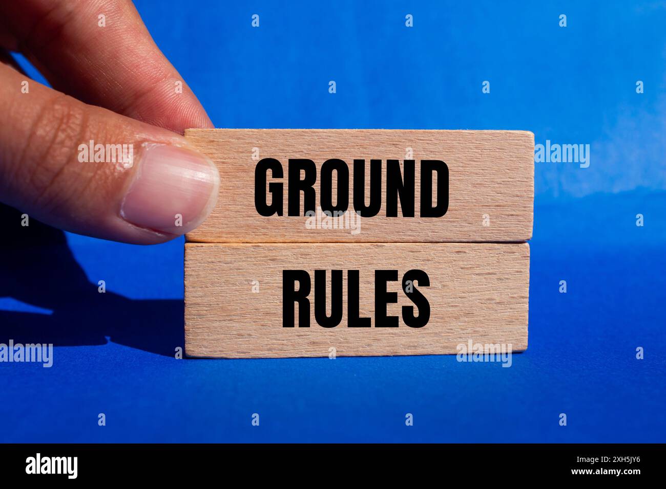 Ground rules message written on wooden blocks with blue background ...