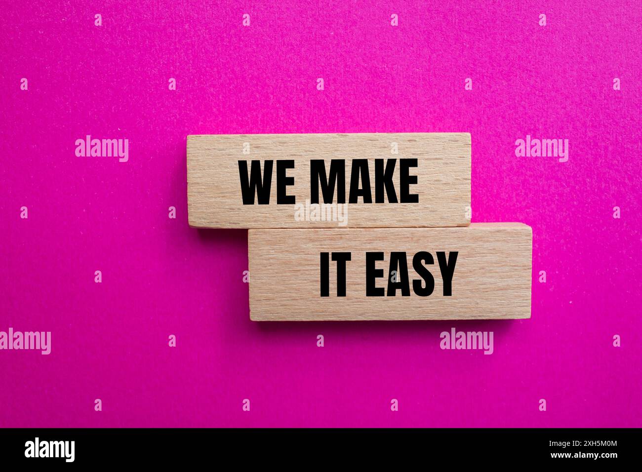 We make it easy message written on wodoen blocks with pink background ...