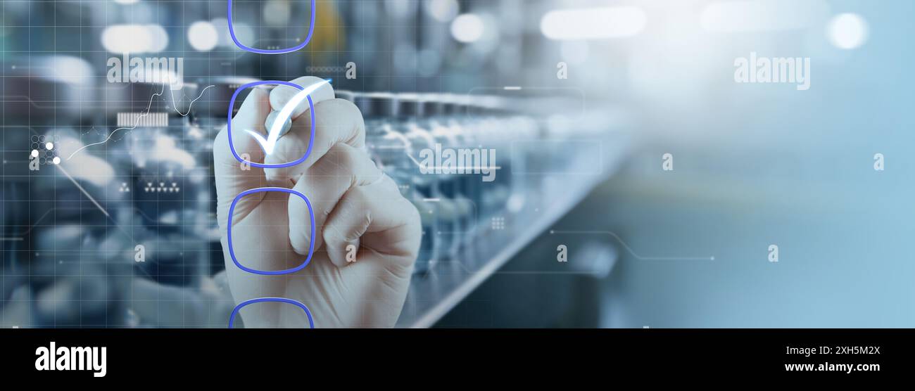 a hand marking checkboxes against a blurred industrial background ...
