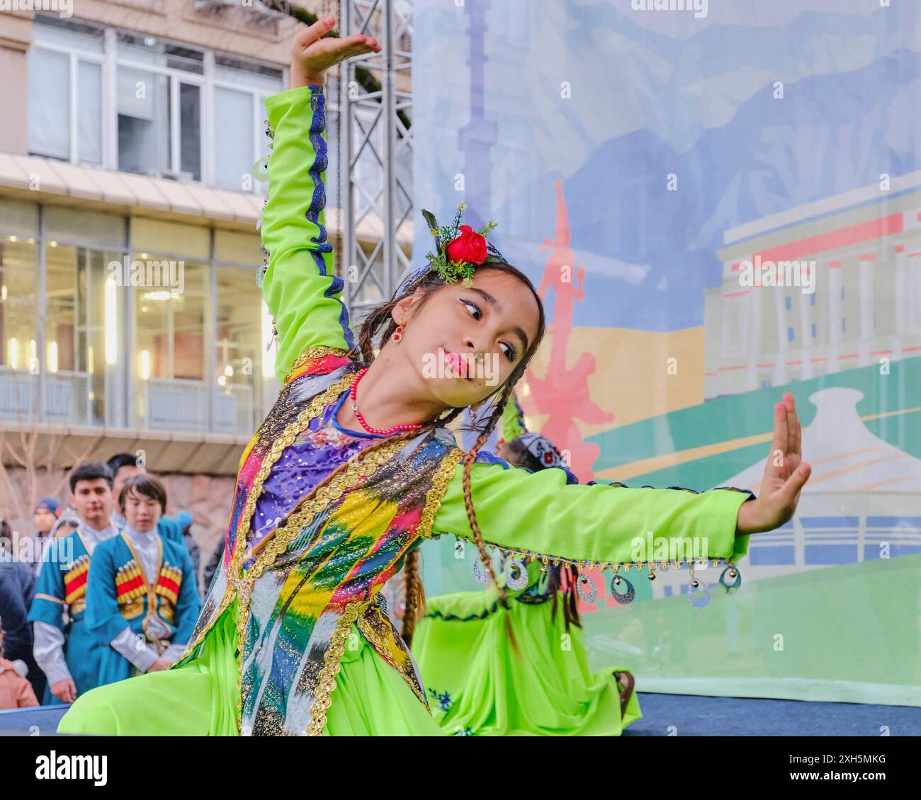 Almaty, Kazakhstan - March 21, 2024: Asian girl with several braids in national traditional ...
