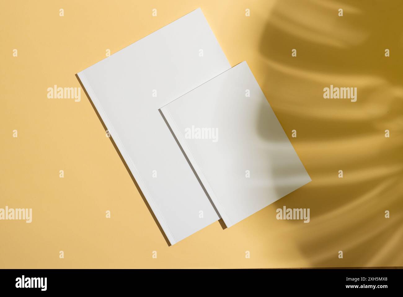 Blank white paper on a yellow background, with copy space. Ideal for ...