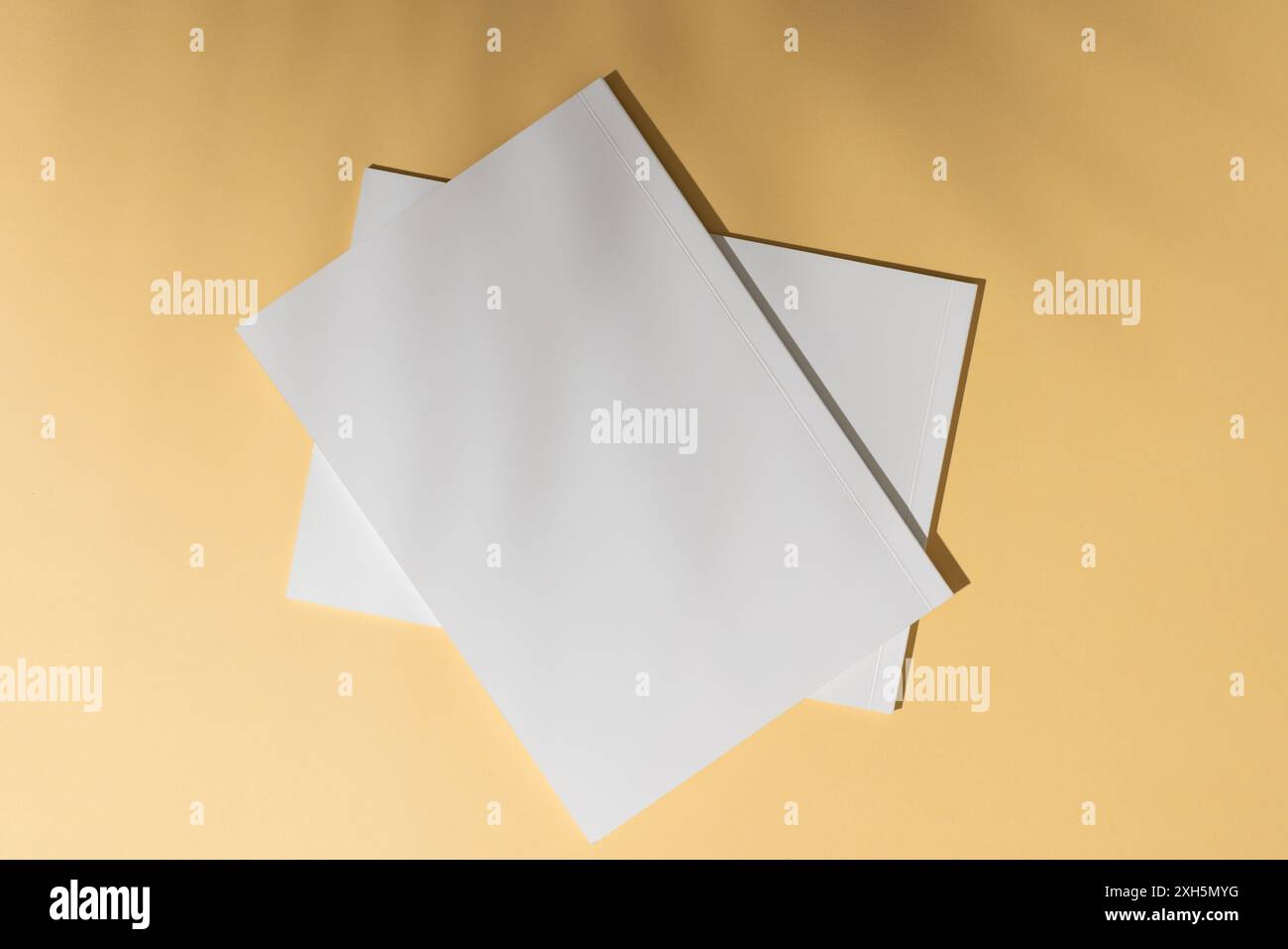 Blank white paper sheets on a beige background, with copy space. Office ...