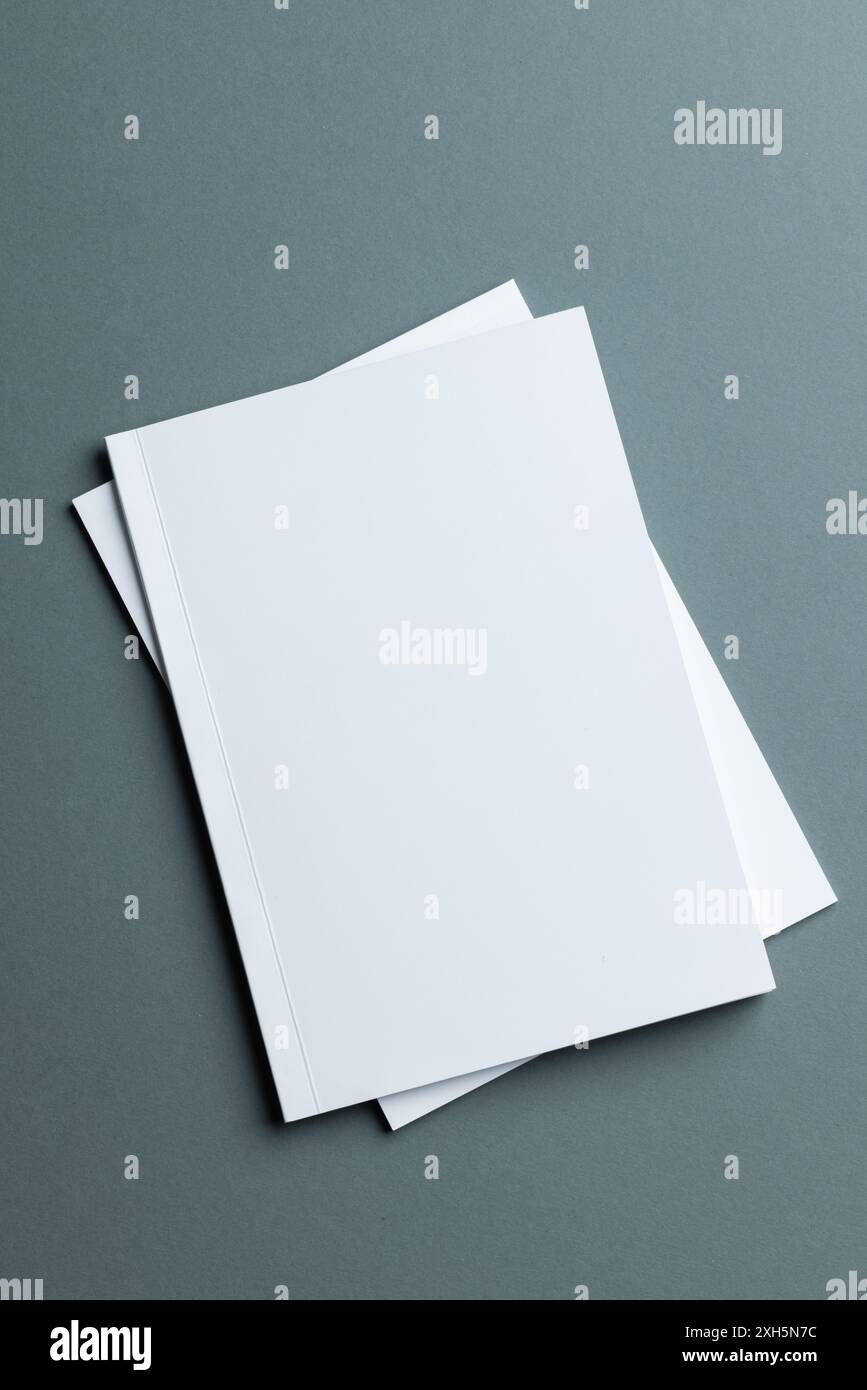 Blank white paper sheets on a gray background, with copy space. Ideal ...