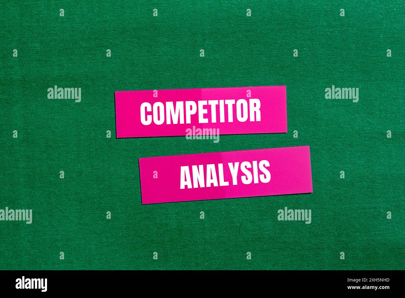 Competitor analysis message written on pink paper with green background ...