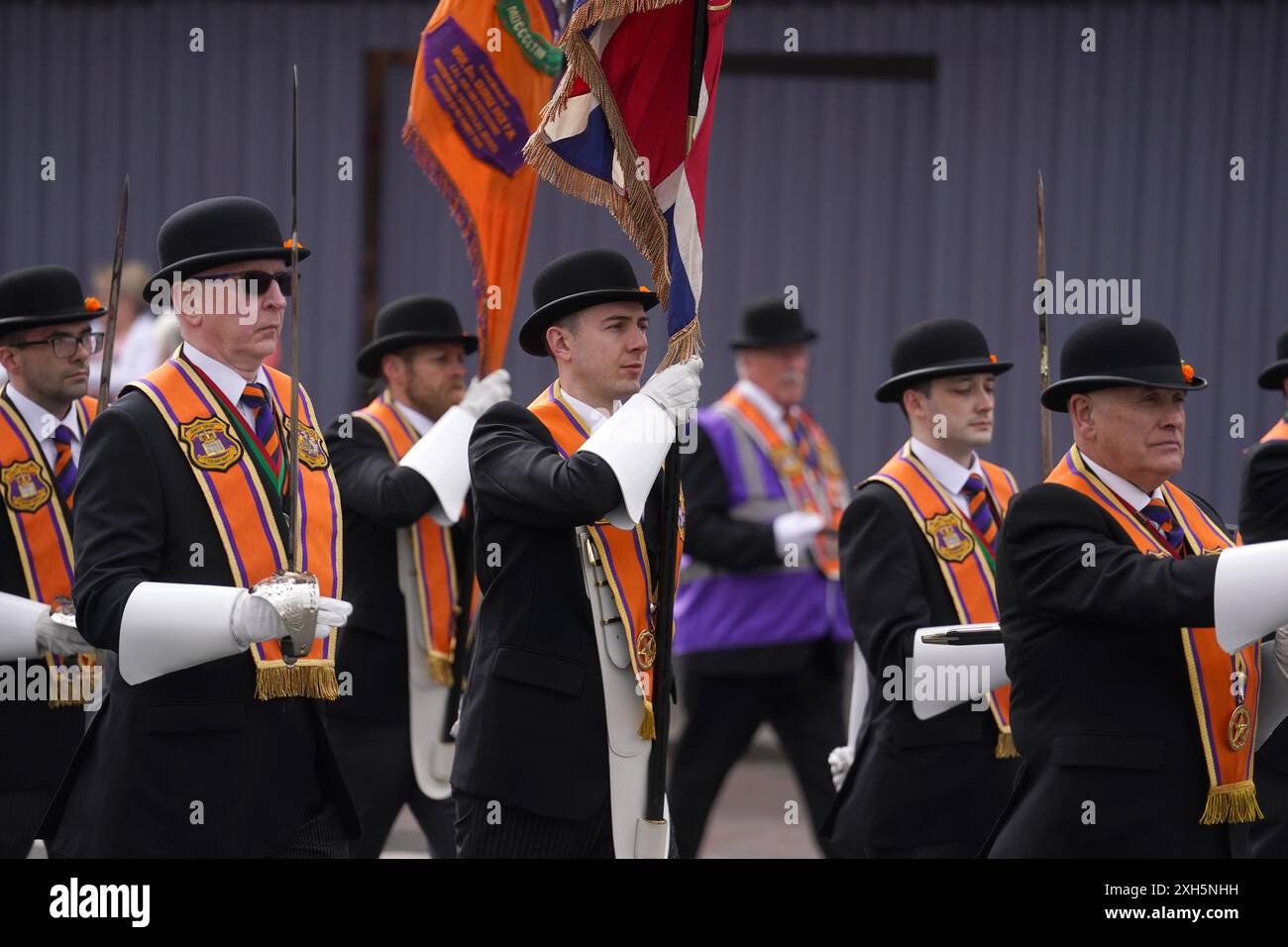 A colour party carrying flags arrive at Carlisle Circus in Belfast ...