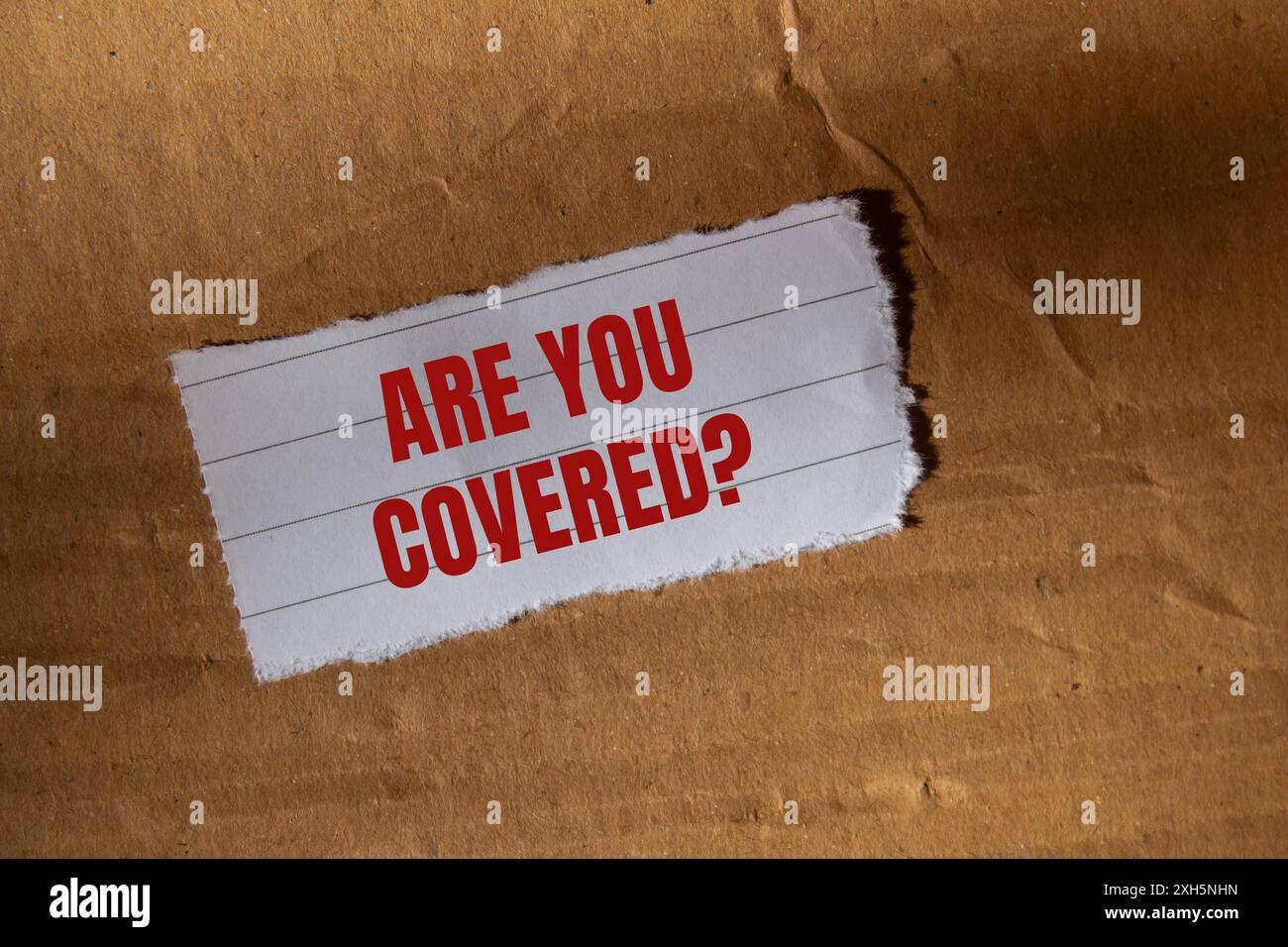 Are you covered question message written on ripped torn white paper ...