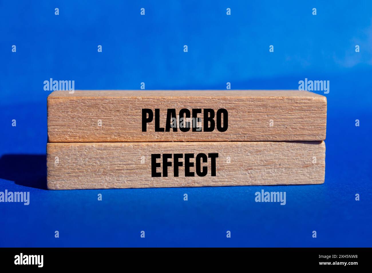 Placebo effect message written on wooden blocks with blue background ...