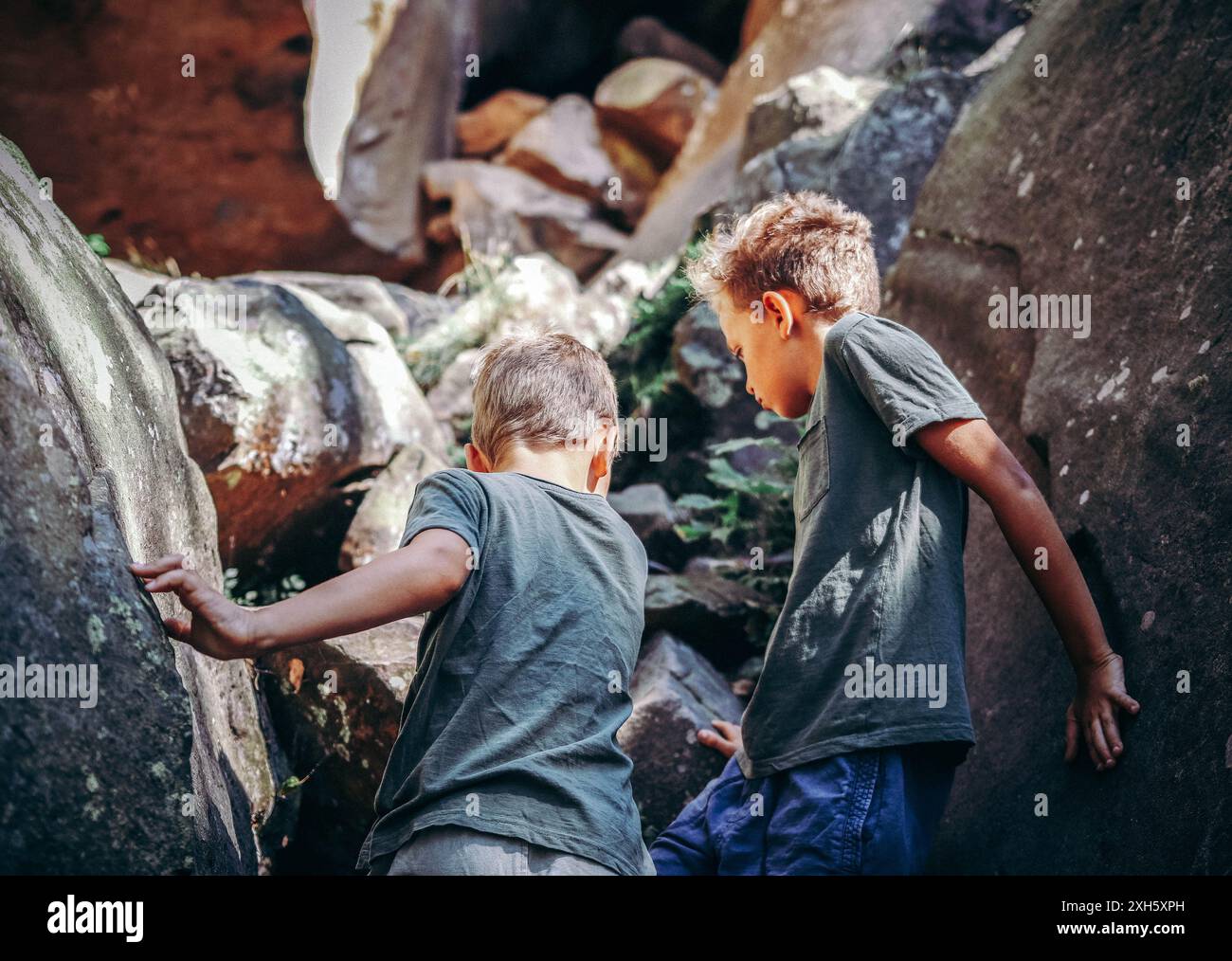 Two boys climbing rock hi-res stock photography and images - Alamy