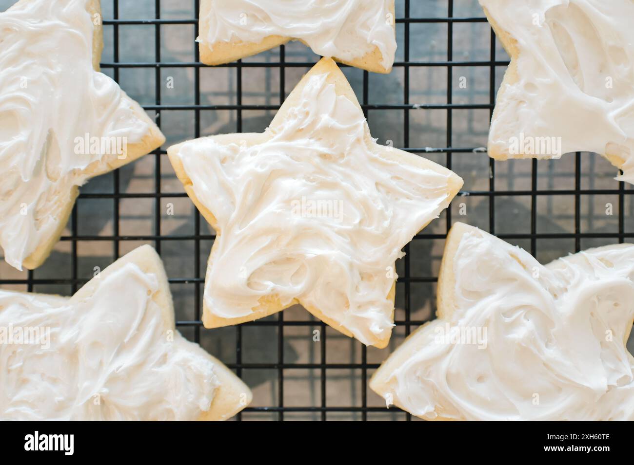 Flatly of start shaped iced sugar cookies on a cooling rack Stock Photo ...