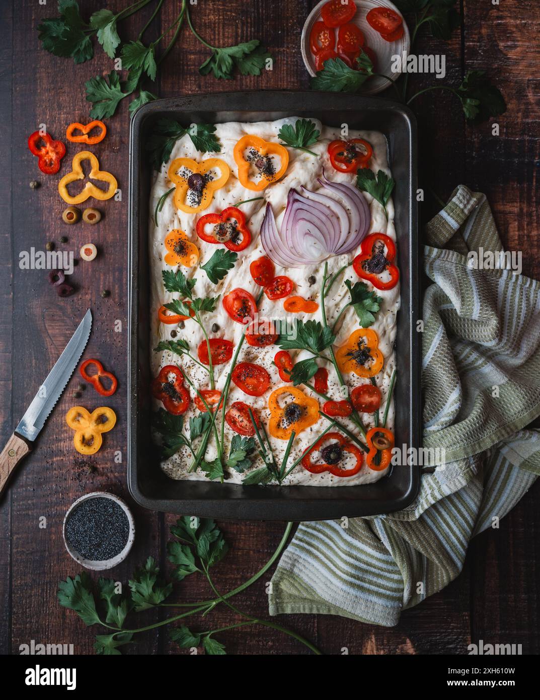 Overhead of pan of focaccia bread dough decorated with vegetables Stock ...