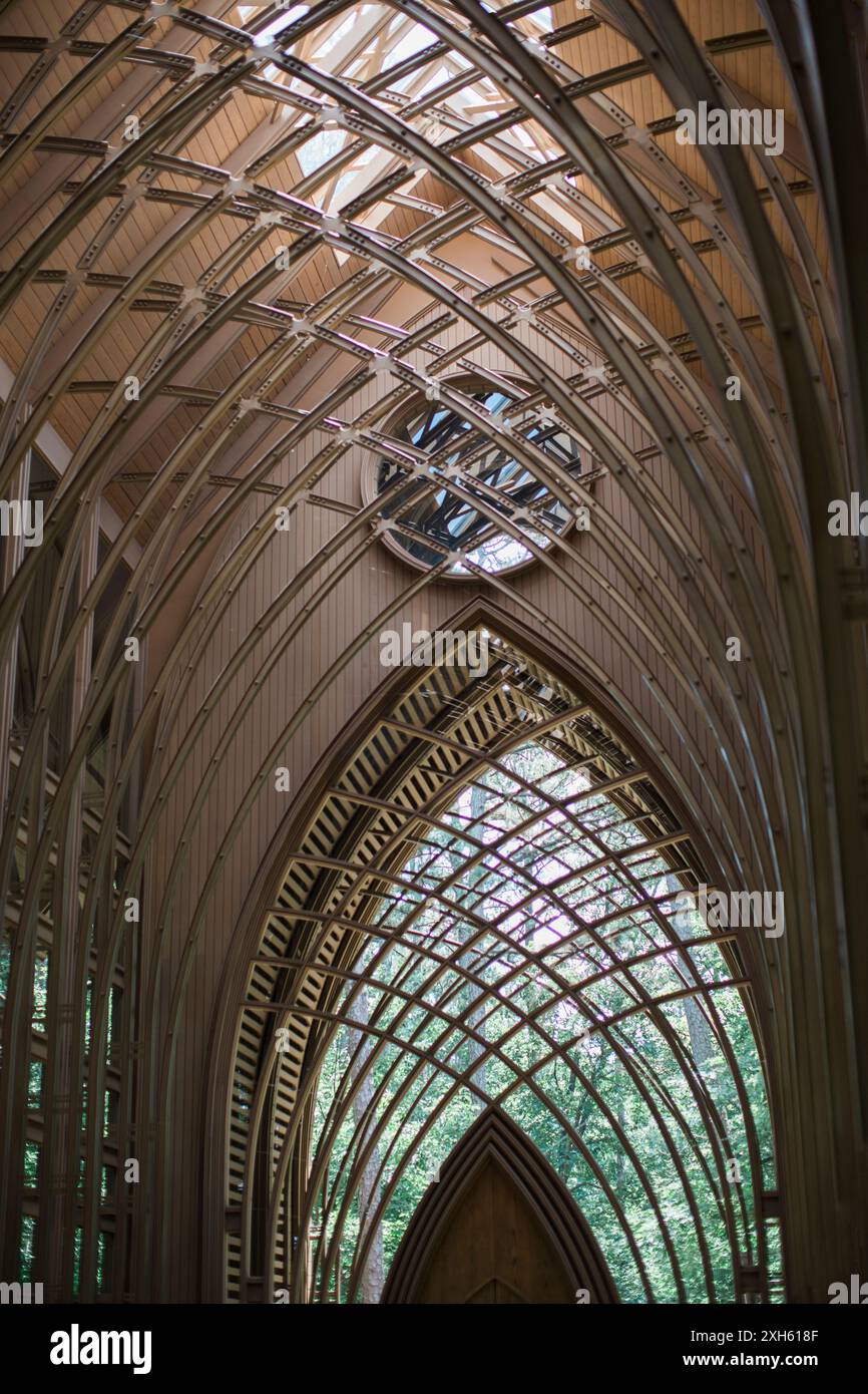 Intricate wooden arches and natural light inside a chapel Stock Photo ...