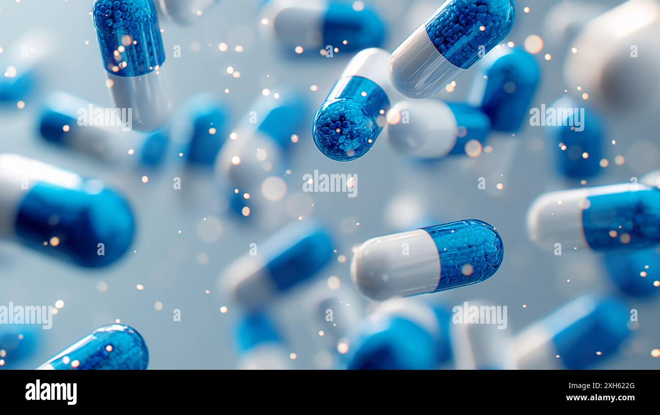 Blue and white capsules falling through the air on blue background ...