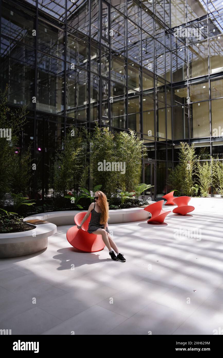 Blonde woman in a glass building Stock Photo - Alamy