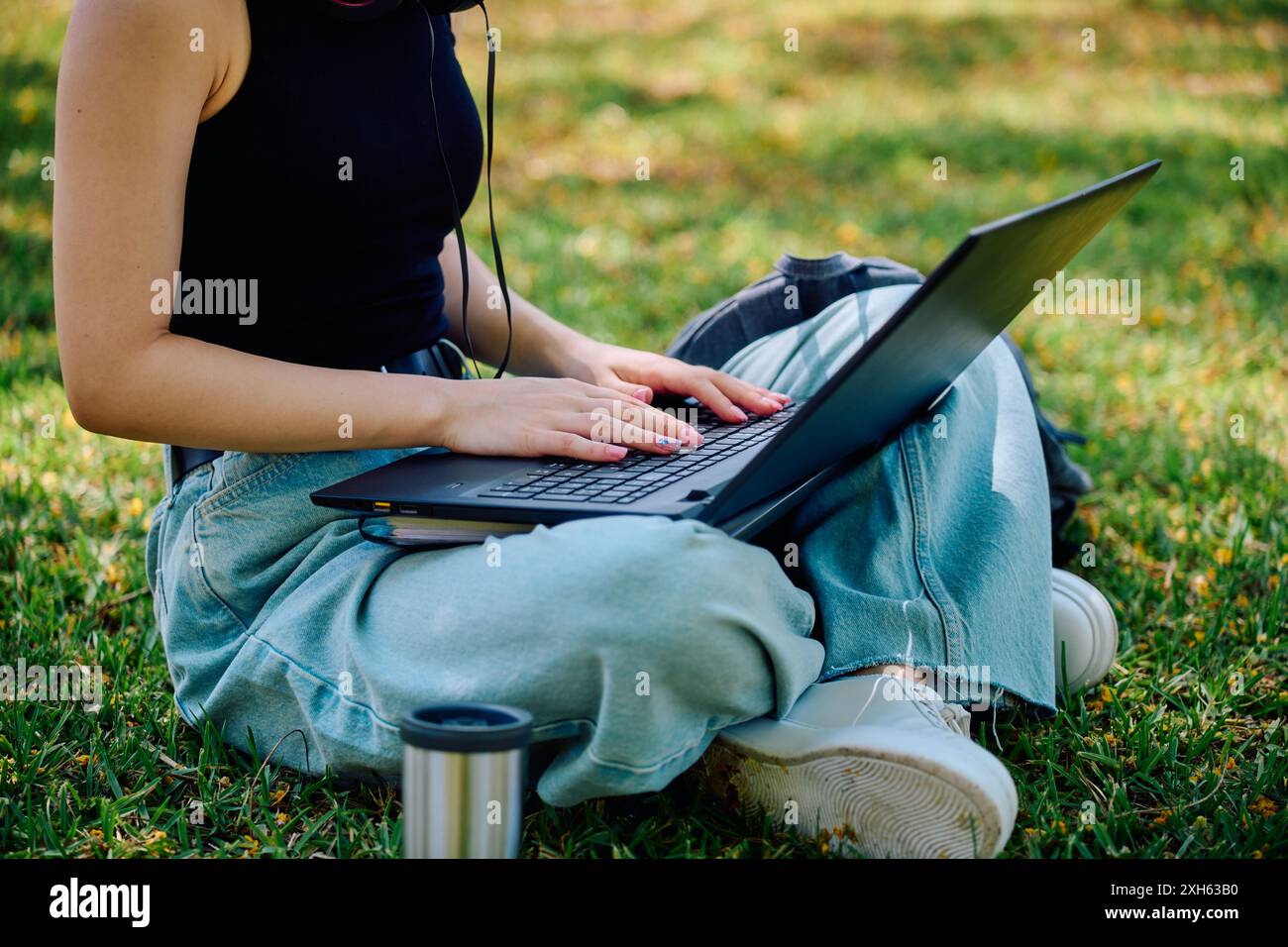 University student typing on laptop outdoors Stock Photo - Alamy