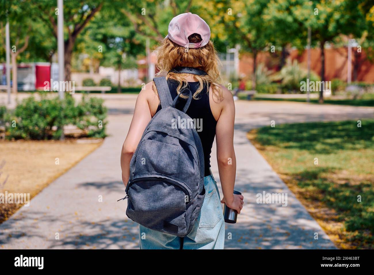 University student walking on campus Stock Photo - Alamy