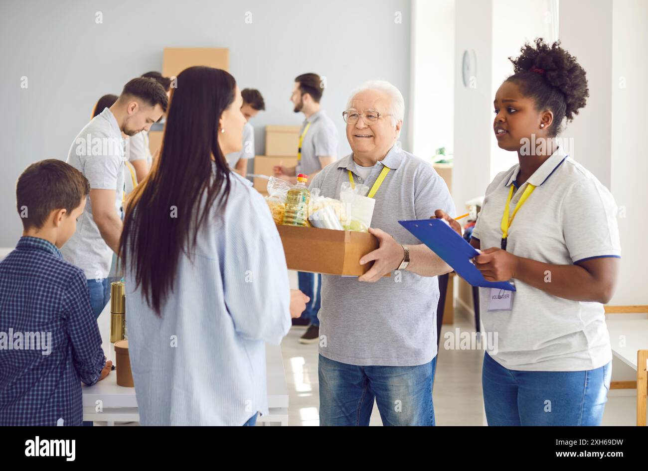 Volunteers Handing Food Box To Refugee Family At Humanitarian Aid ...