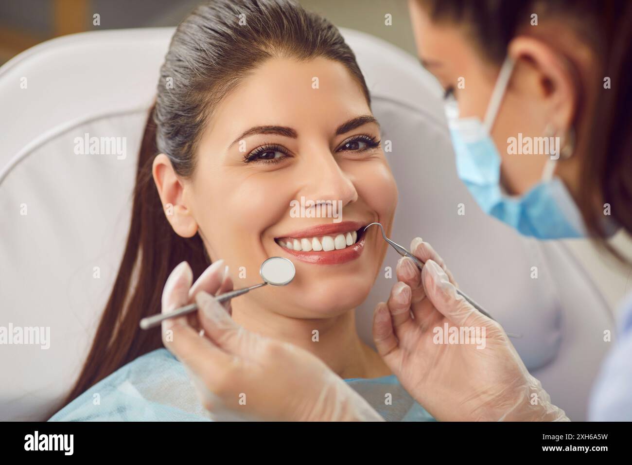 Dentist Examining Or Treating Teeth Of Happy Patient During Hospital ...