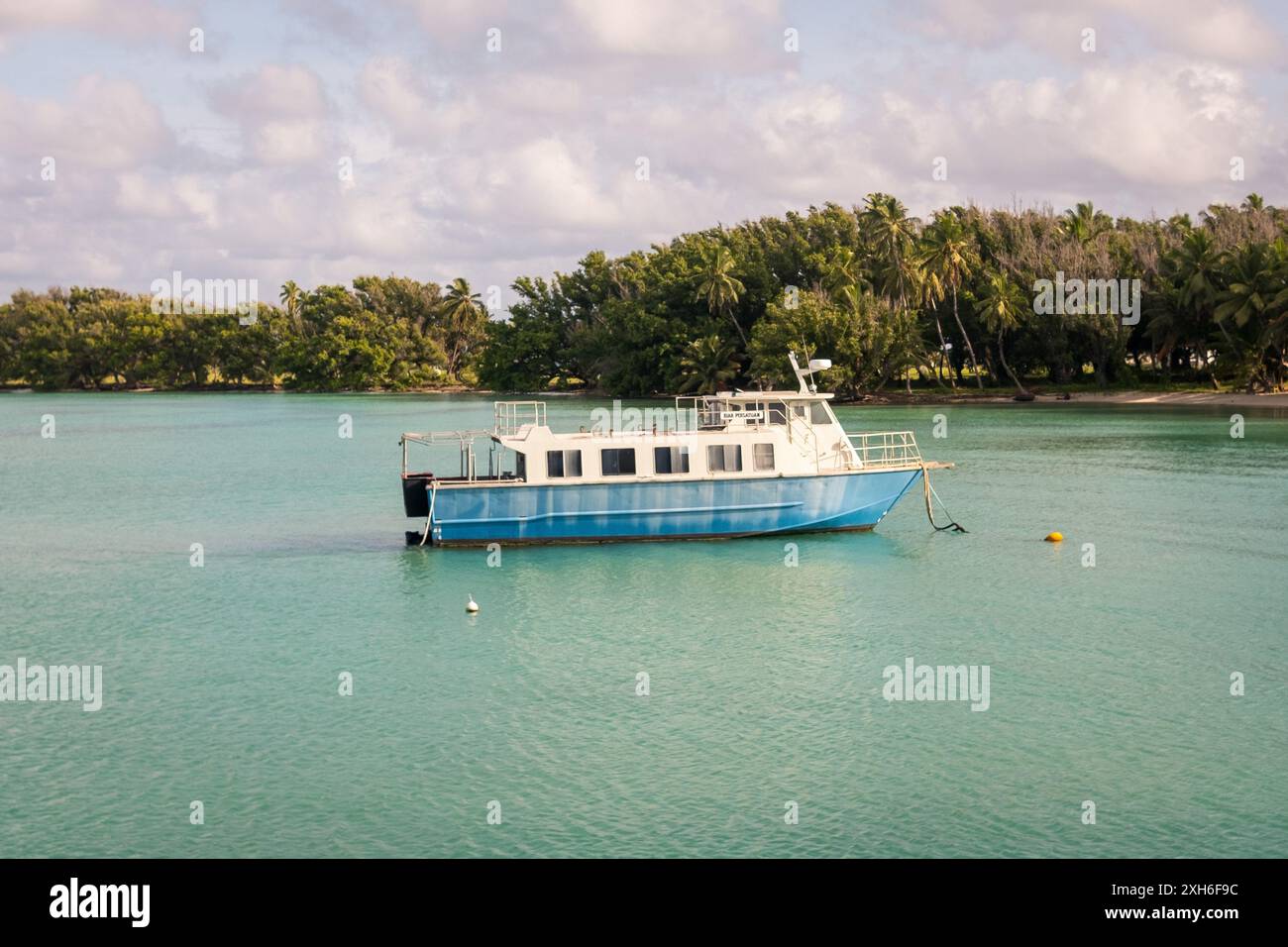 A now decommissioned ferry moored in the bay at Home Island, one of the ...