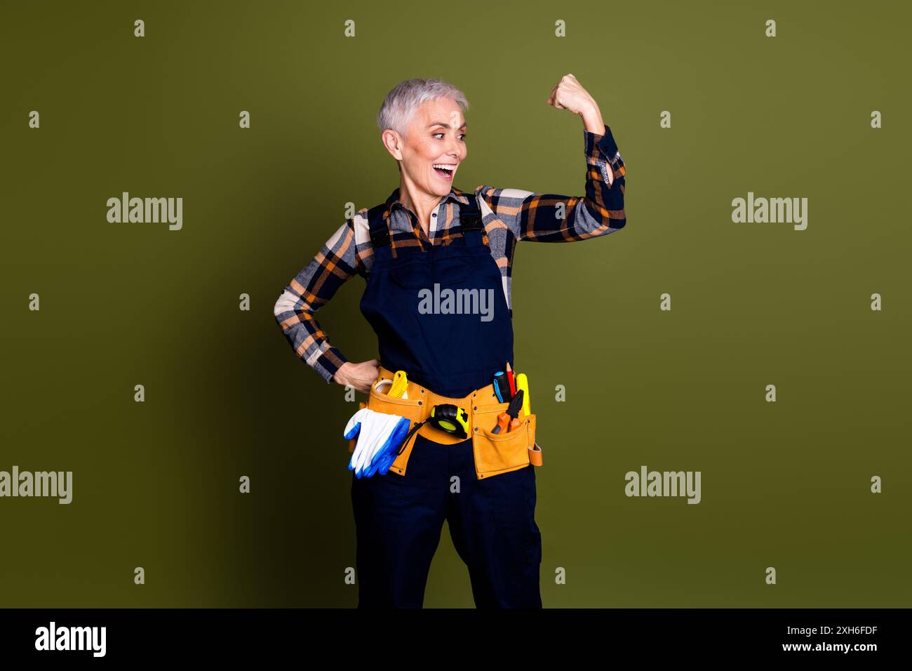 Photo of pensioner lady manual worker engineer look amazed show muscles ...