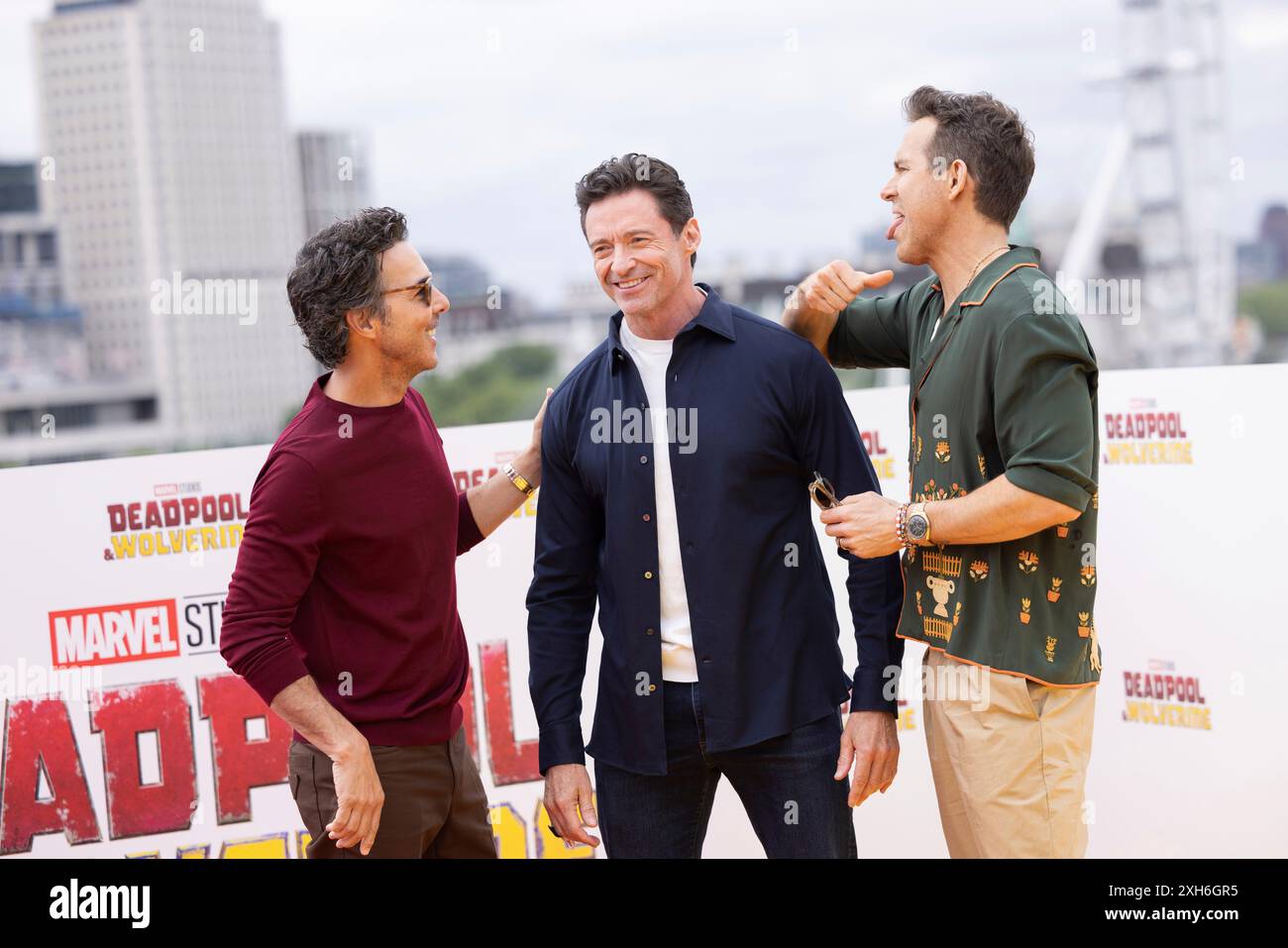 Ryan Reynolds, from right, Hugh Jackman and Shawn Levy pose for photographers at the photo call ...