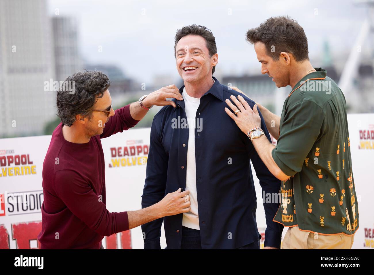 Ryan Reynolds, from right, Hugh Jackman and Shawn Levy pose for photographers at the photo call ...