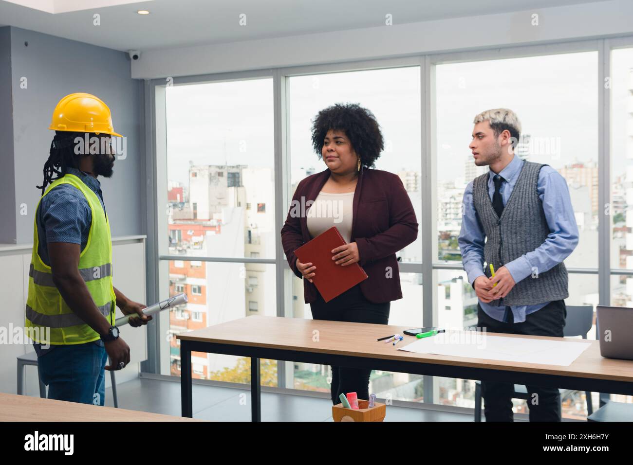 African Man with safety helmet and vest, engineer in charge of work, is ...