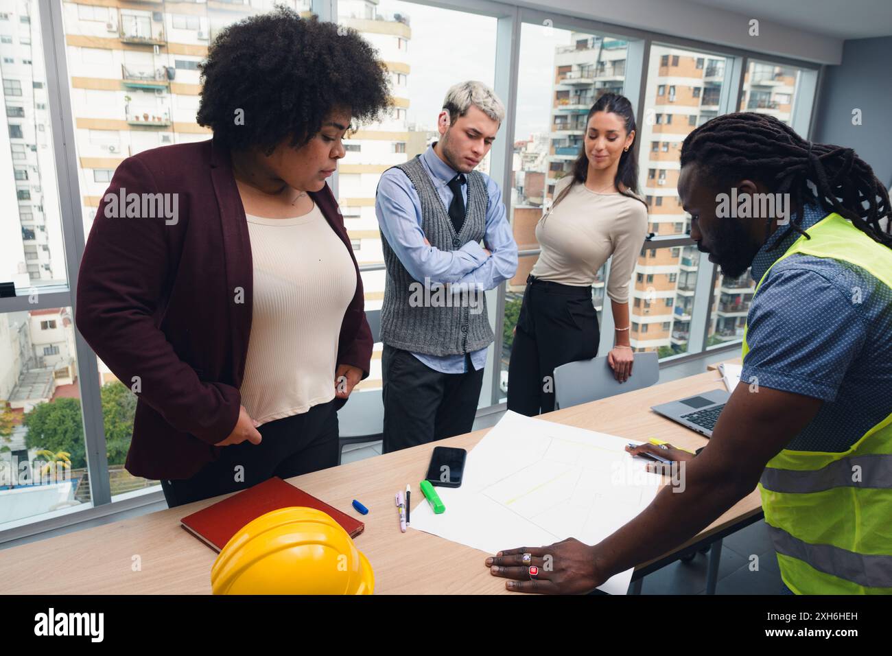 Engineer man with dreadlocks is explaining plans of work in board ...
