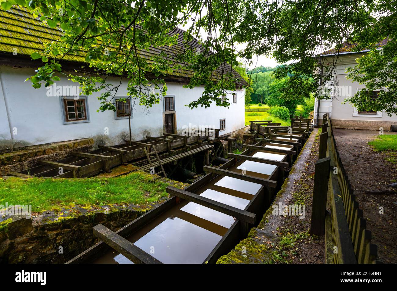 The mill in Babiccino Valley is a historic structure set amidst lush ...