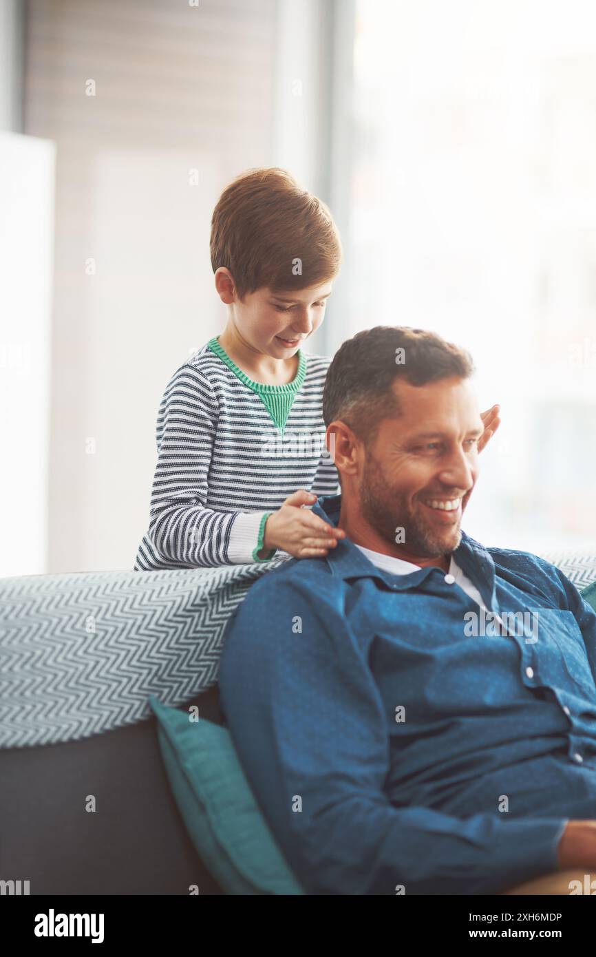 Father, boy and massage shoulders in home, bonding and love for funny ...