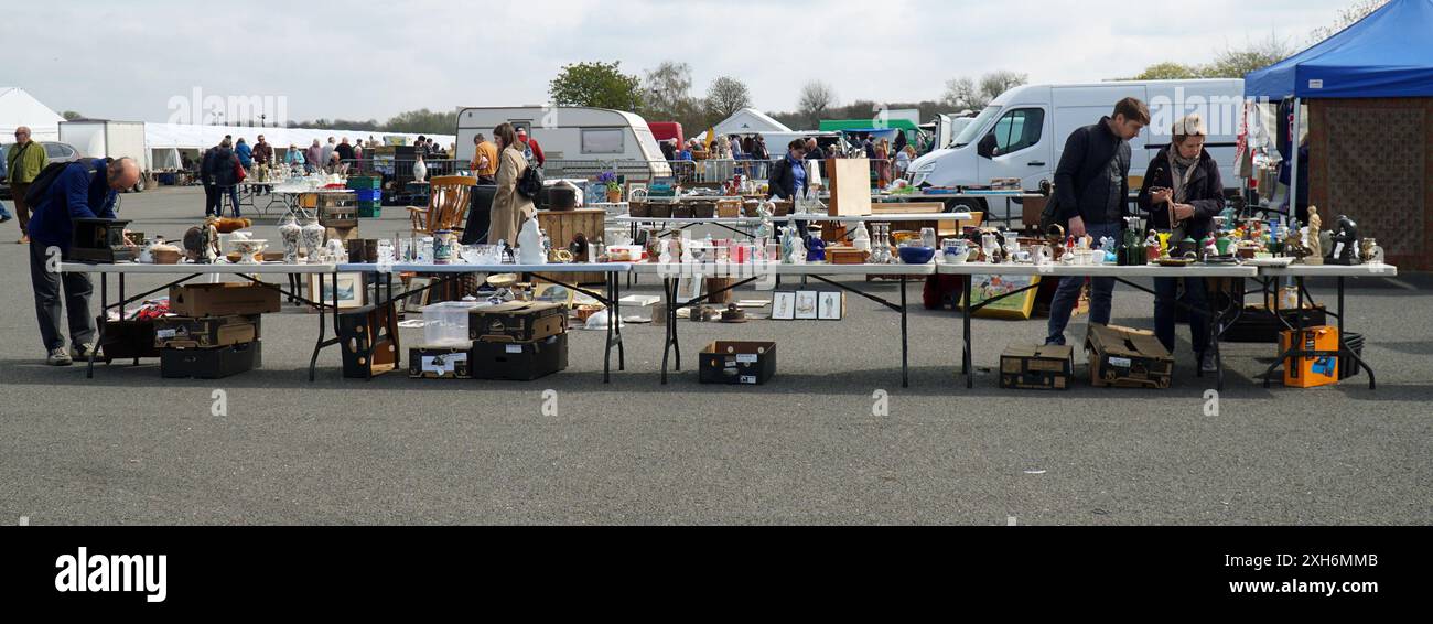 Tables with goods and shoppers at antique fair Stock Photo - Alamy