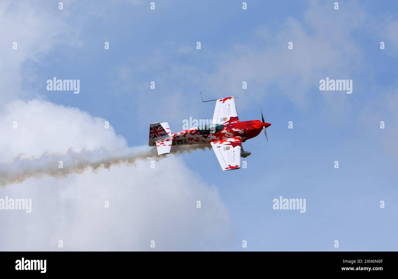 Global All Stars Extra 300S stunt aircraft in flight with smoke Stock ...