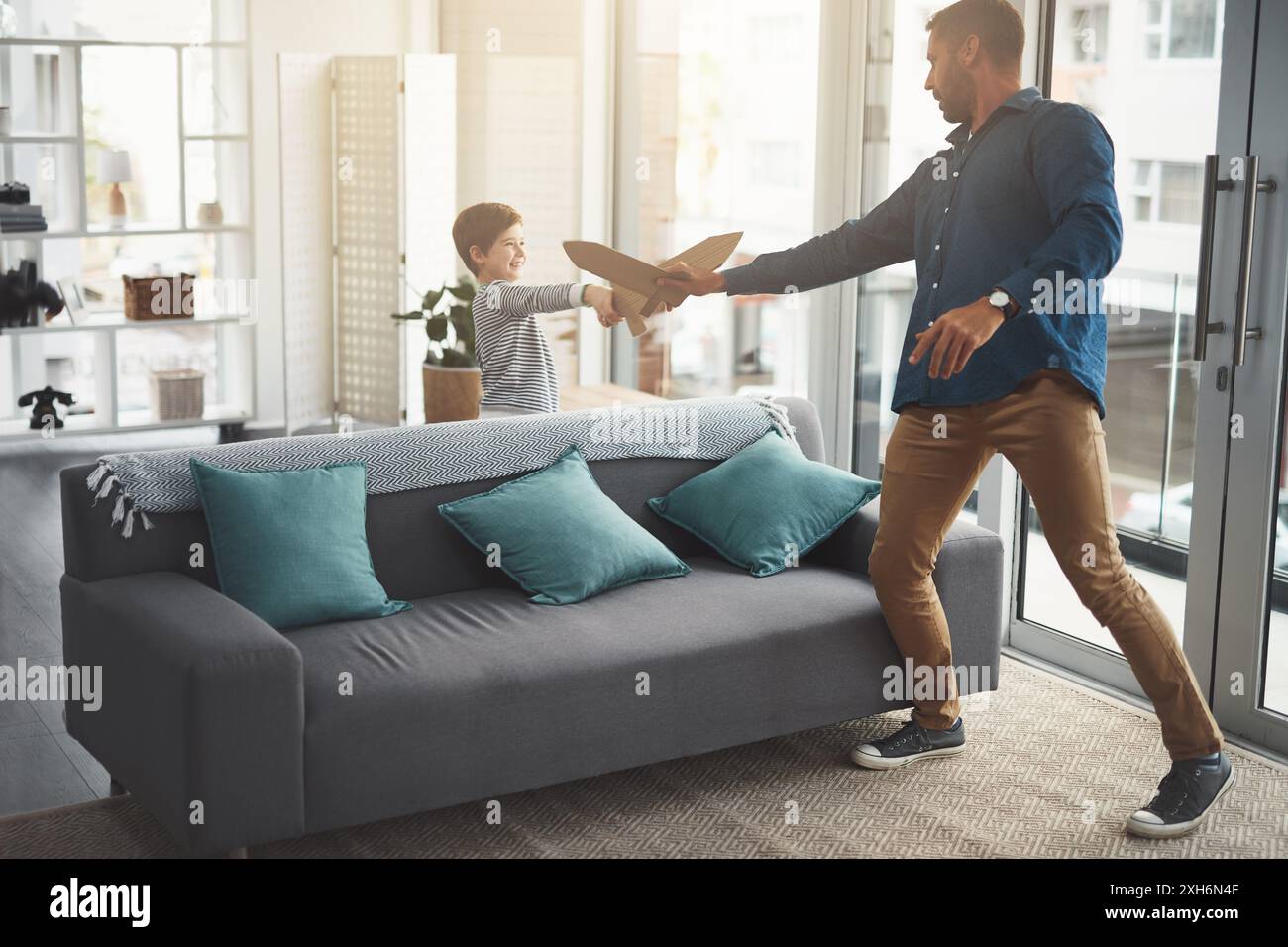 Father, boy and toys for playing together in home, bonding and swords ...