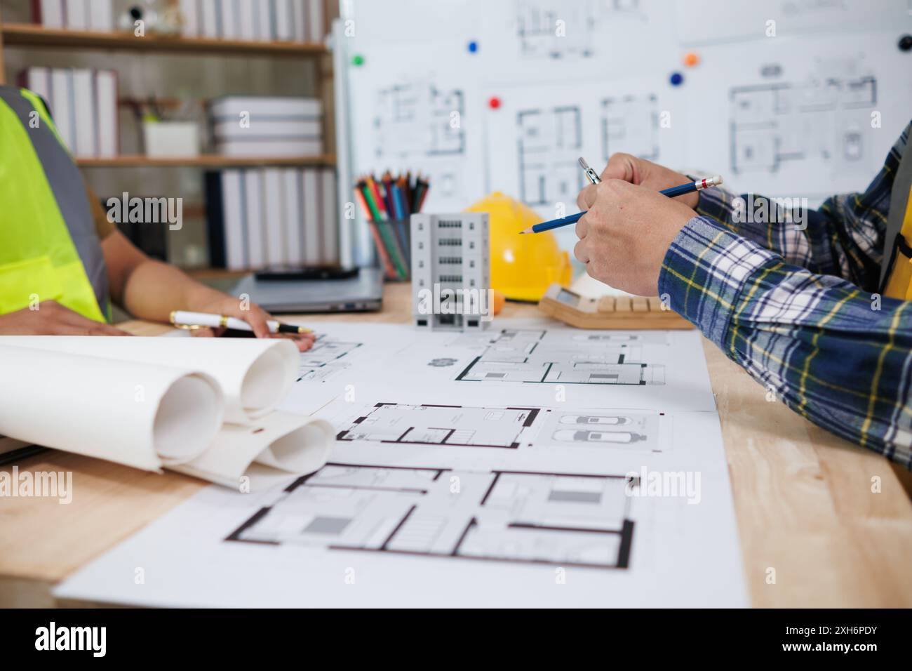 A team of engineers and architects discuss house plan design and ...