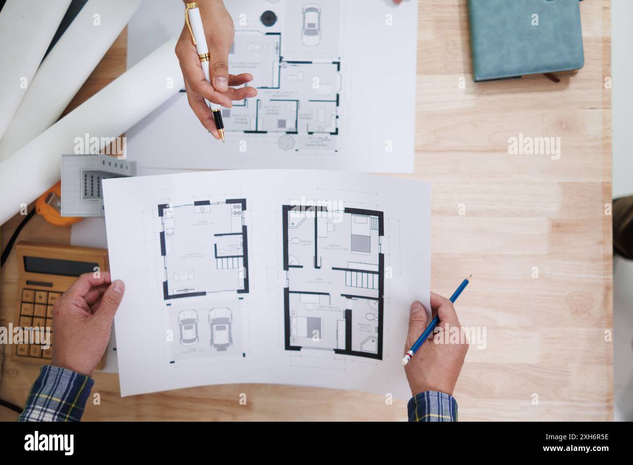 A team of engineers and architects discuss house plan design and ...