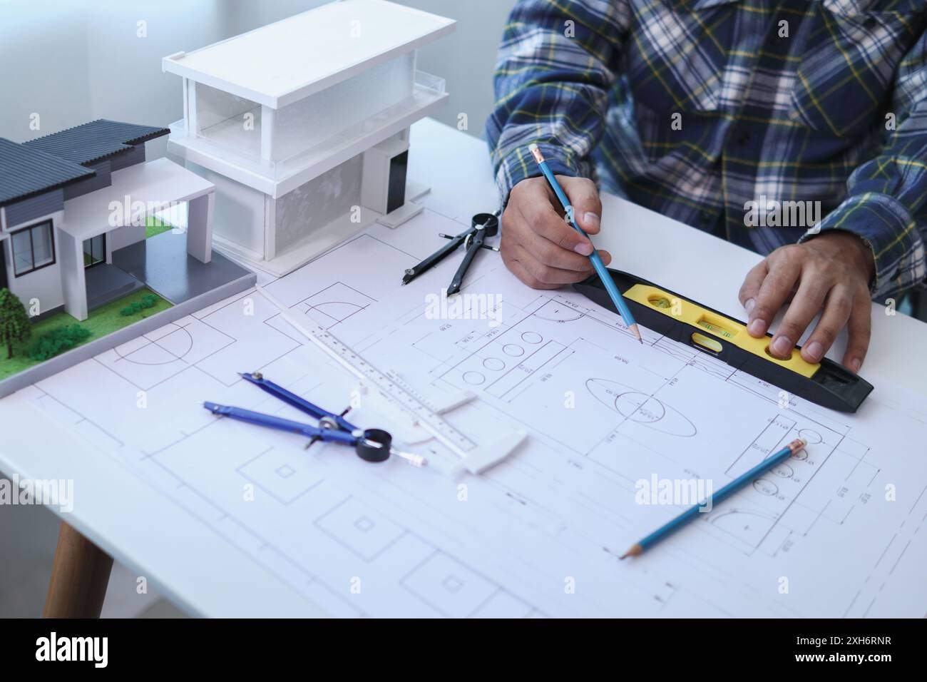 A team of engineers and architects discuss house plan design and ...