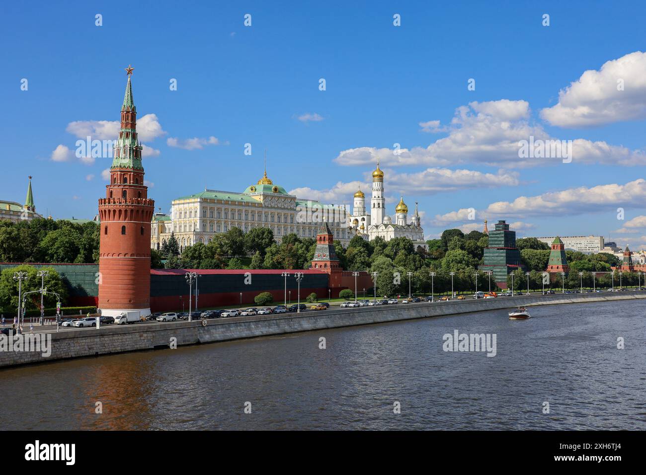 View of the Kremlin embankment and Moscow river on blue sky background ...