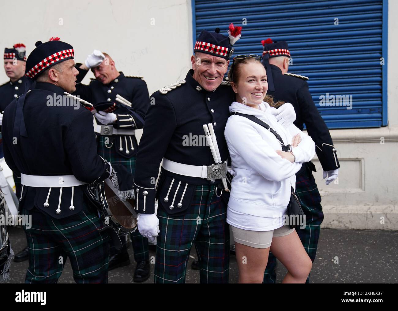 People gather at Carlisle Circus in Belfast ahead of an Orange Order ...
