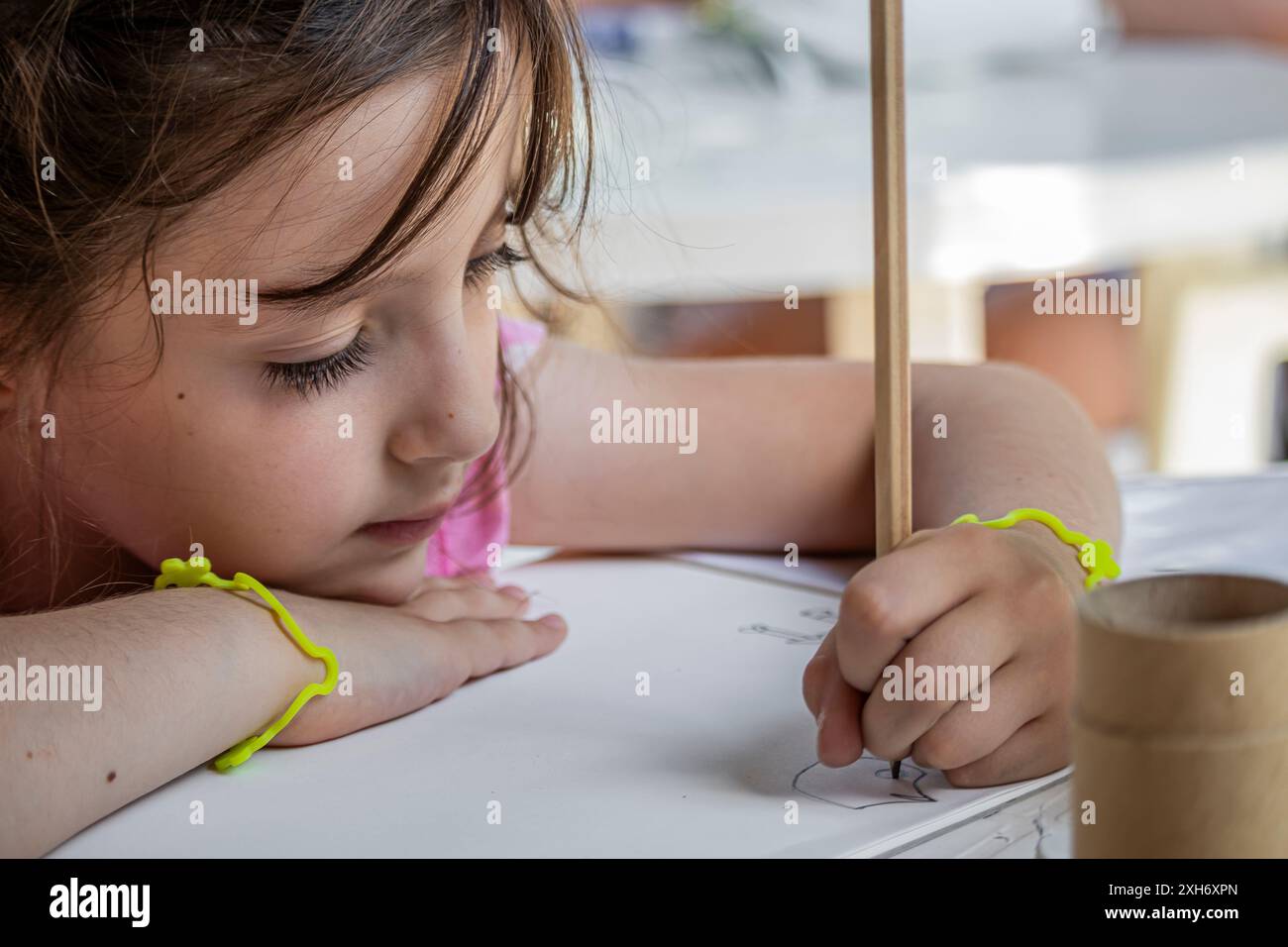 A small and pretty little girl, disheveled and sweaty on a hot summer ...