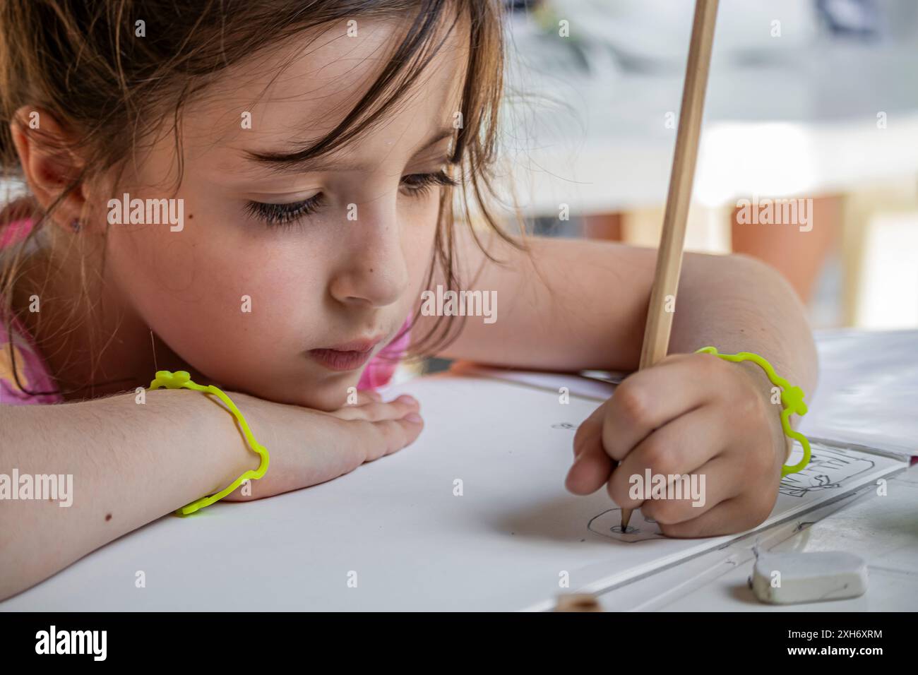 A small and pretty little girl, disheveled and sweaty on a hot summer ...