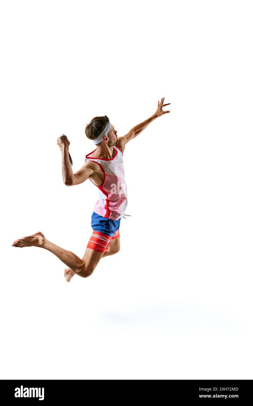 Male tennis athlete in sportswear performing a swing with multicolored ...