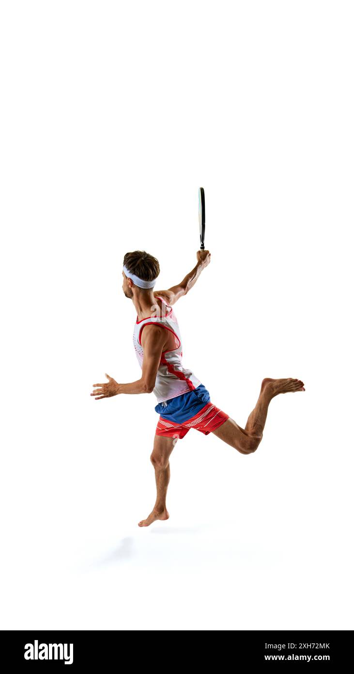 Male tennis athlete in sportswear performing a swing with multicolored ...